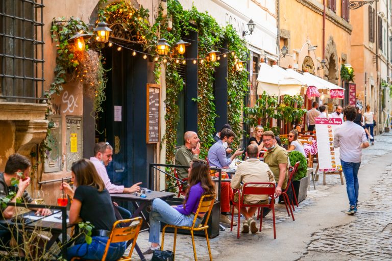 Some customers enjoy an aperitif in a bar in the ancient Trastevere ...